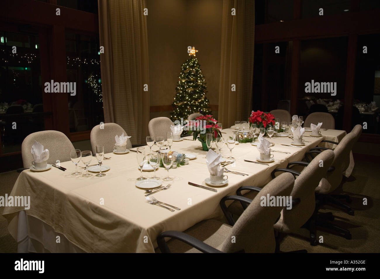 White linen and stemware on table set for guests in conference room ...