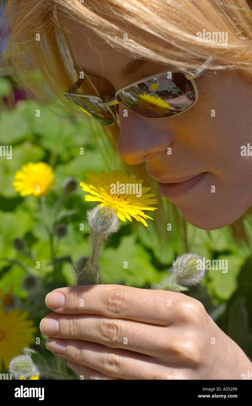 Woman smelling a flower Stock Photo - Alamy