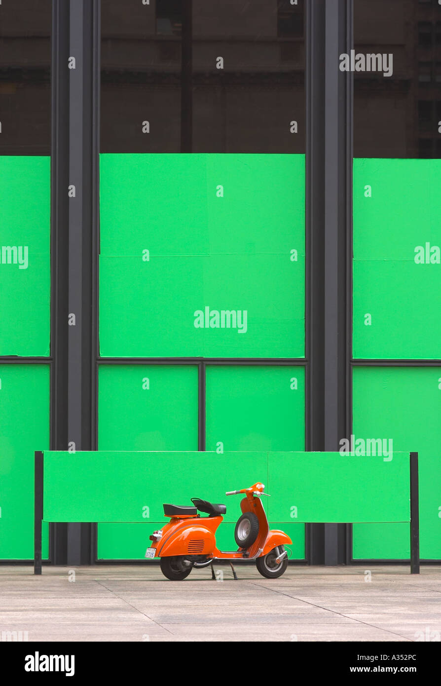 Orange Vespa on bright green backdrop. Outdoor location Stock Photo - Alamy