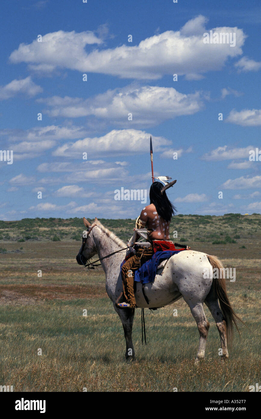 Indian warrior watches settler wagons crossing Western frontier of the ...