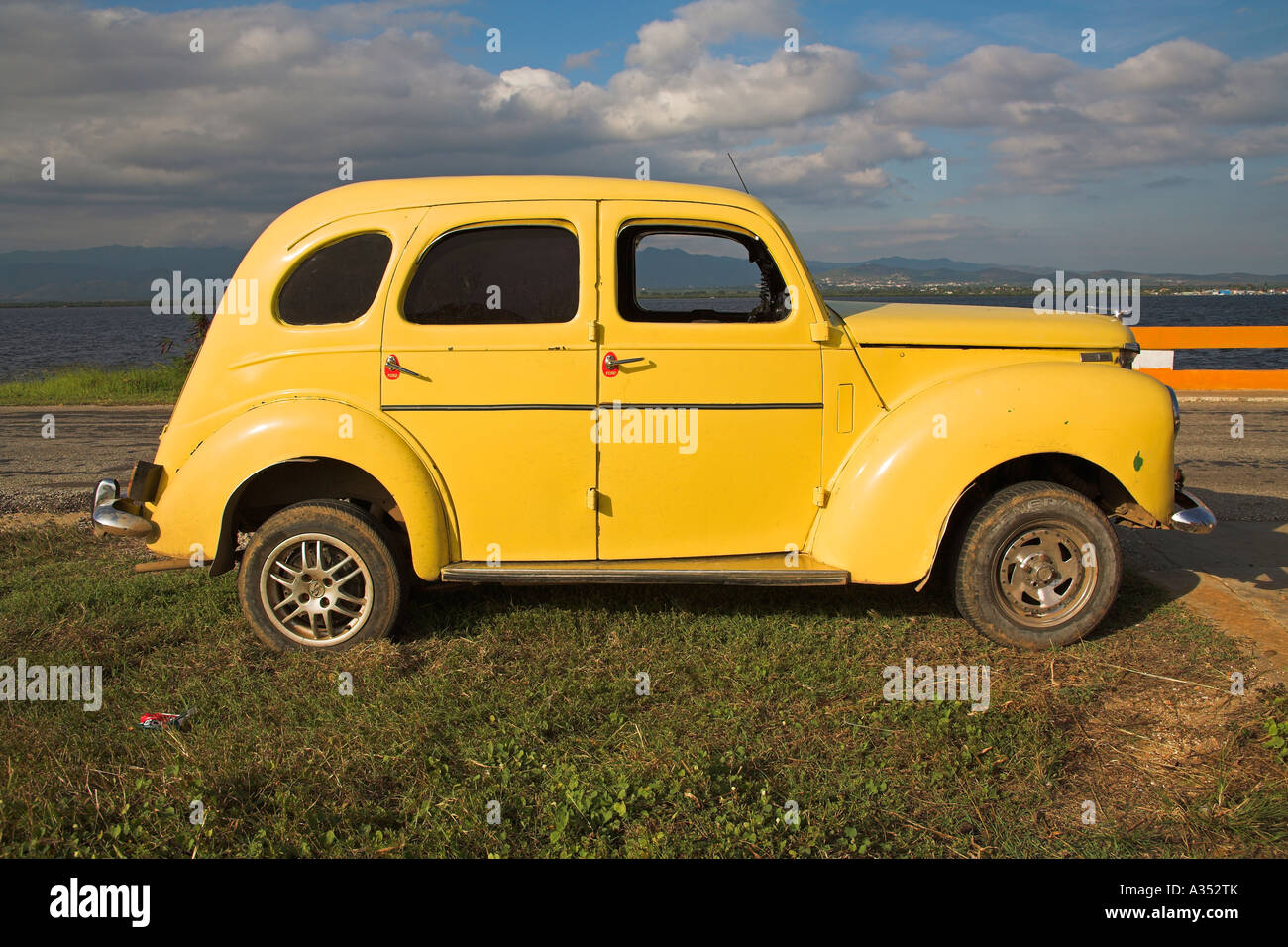 Yellow 1952 Ford Prefect classic British car parked at the roadside ...