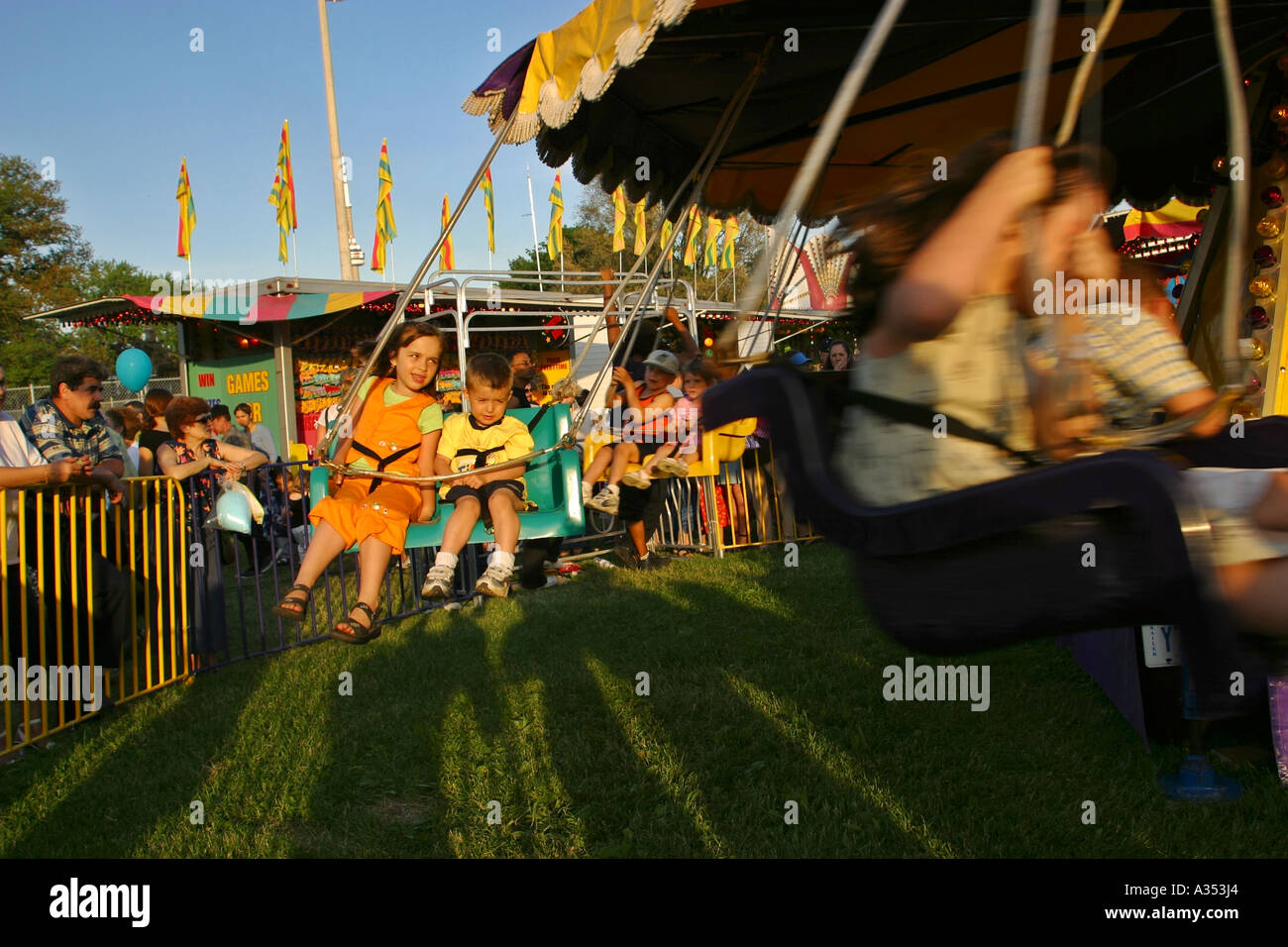 Children riding on a carousel Stock Photo - Alamy