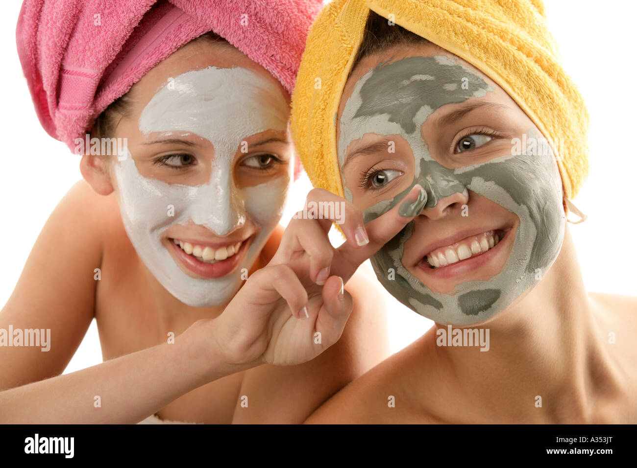 Young woman applying mud mask on her friend's nose Stock Photo - Alamy