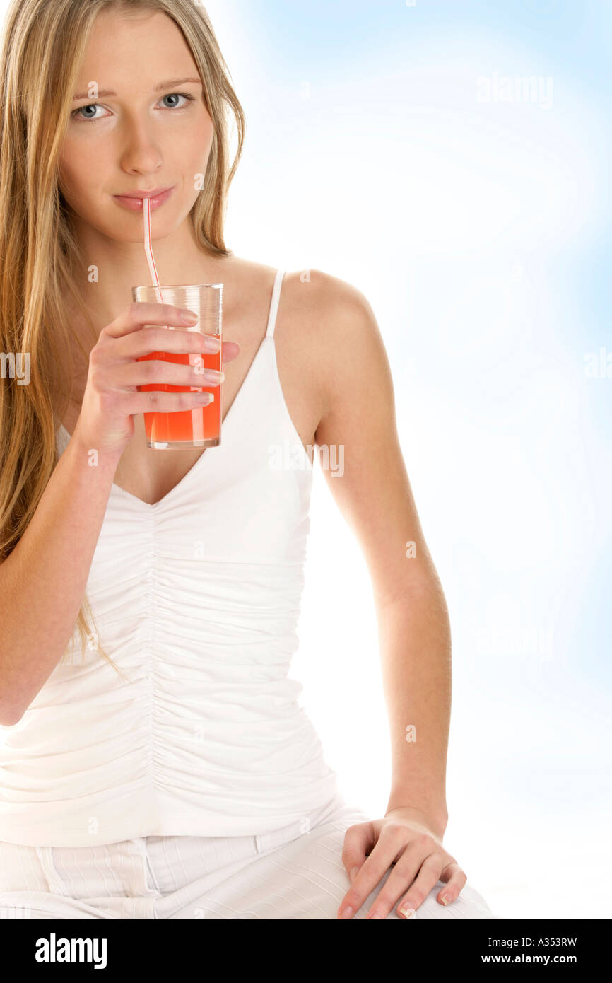 Woman sipping juice Stock Photo - Alamy
