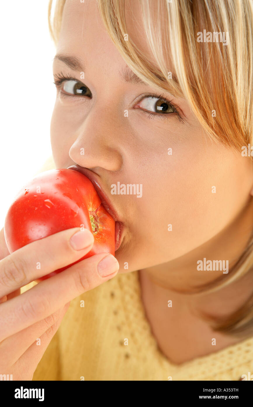 Woman eating tomato Stock Photo - Alamy