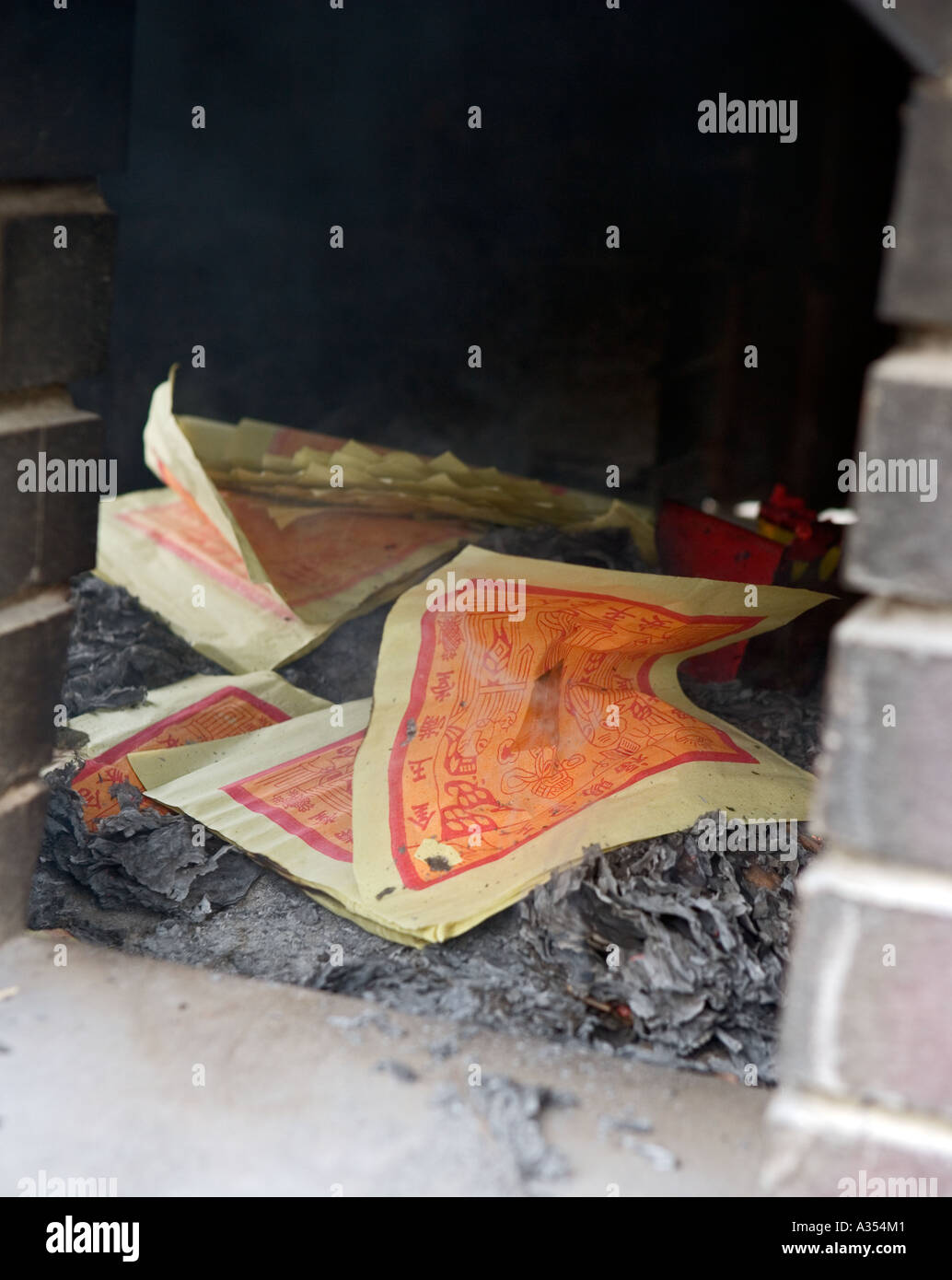 Burning paper money at Chinese temple on Pulau Ketam, Malaysia Stock ...