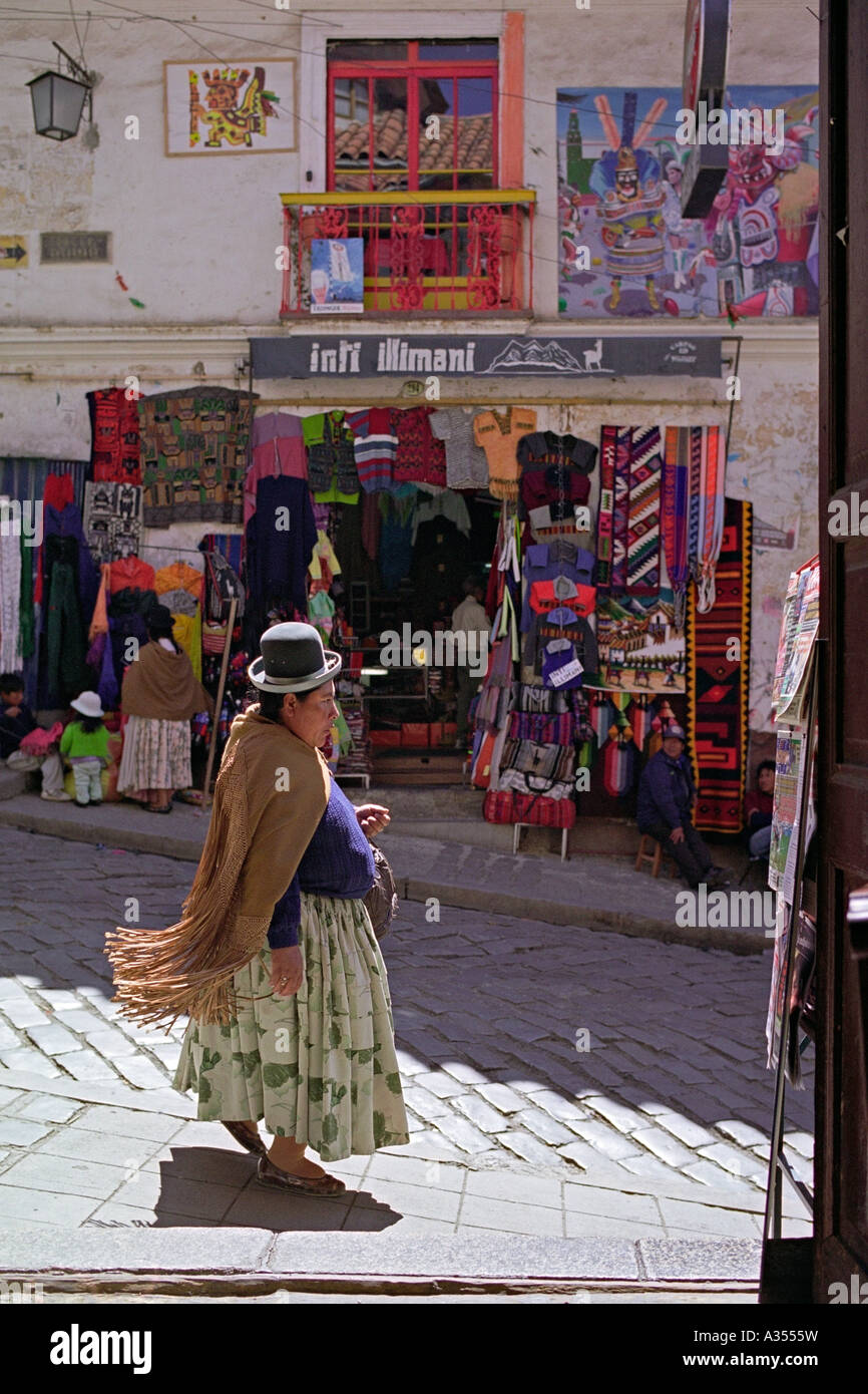 An Aymara indigenous woman dressed in traditional clothing walks past ...