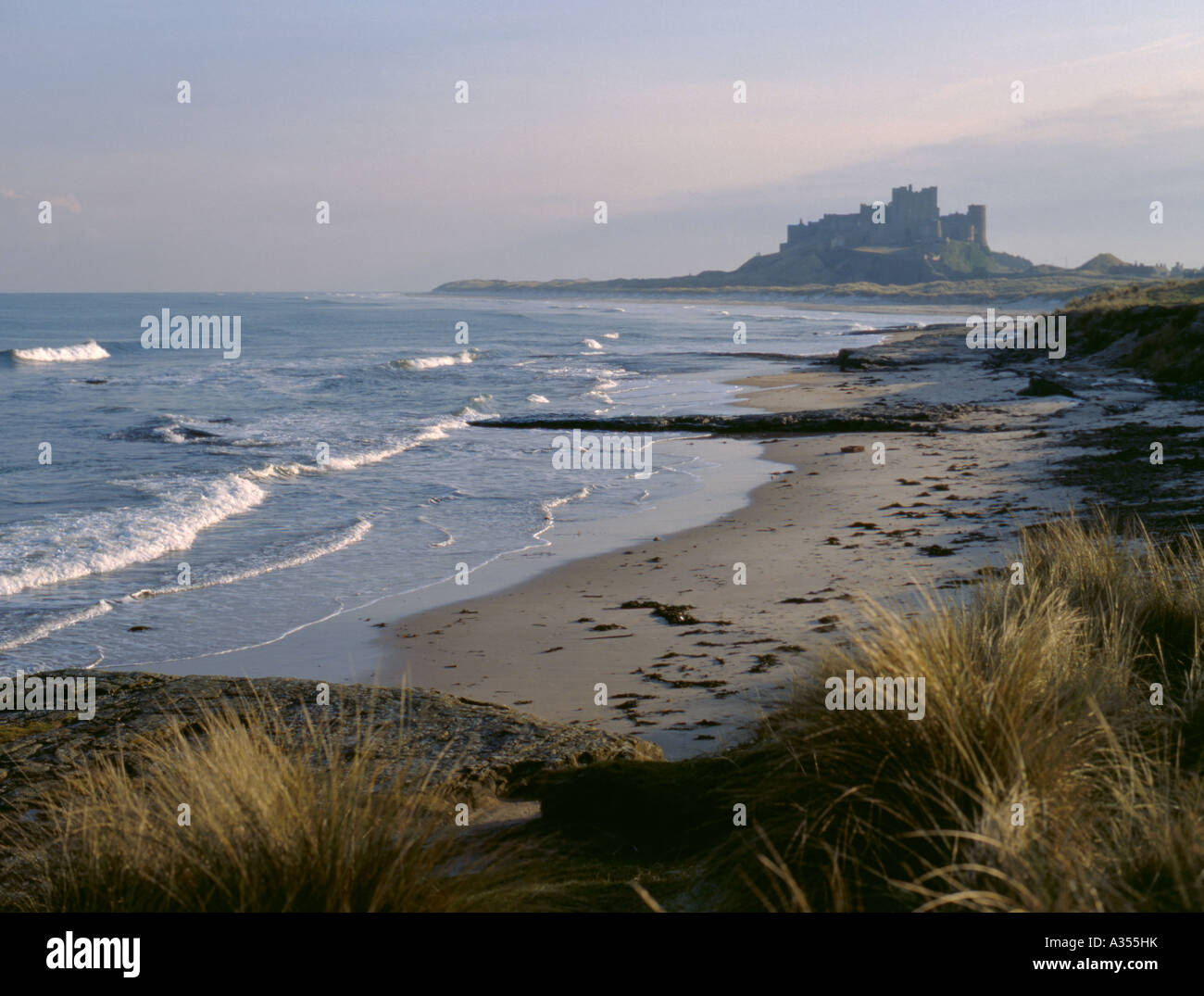 Bamburgh Castle seen over beach, Bamburgh, Northumberland, England, UK ...