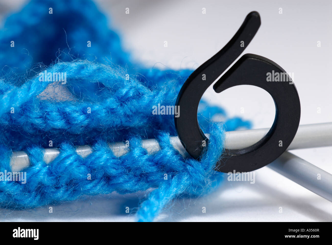 Knitting on four needles with" blue wool" and ^row marker Stock Photo ...