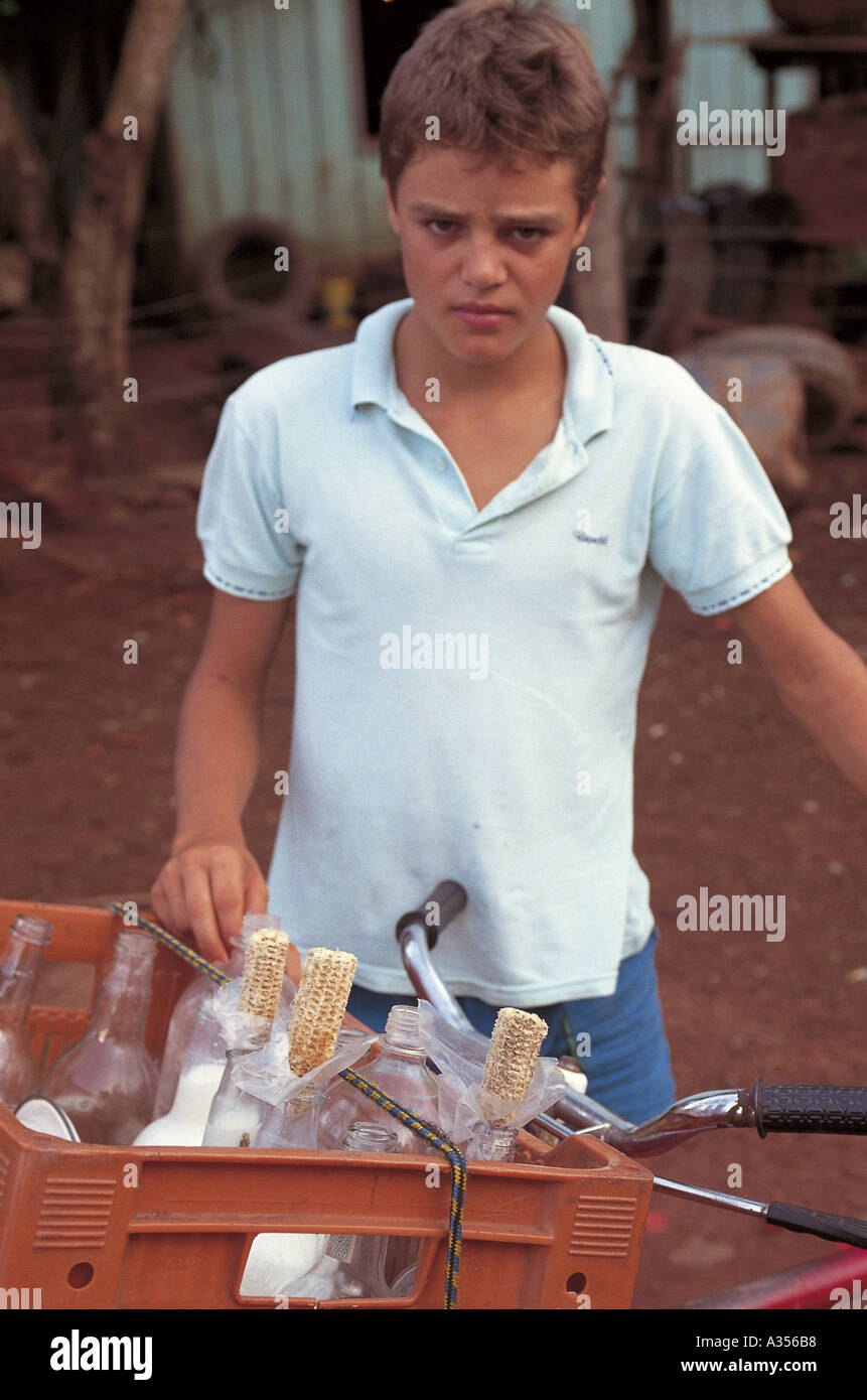 Juruena Brazil Man with bicycle delivering milk in bottles with ...