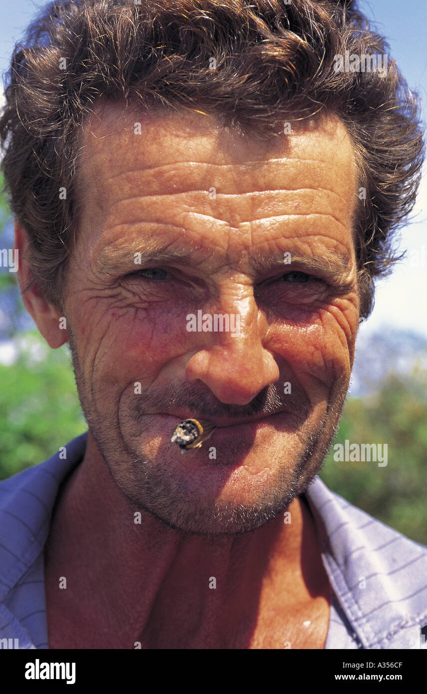 Juruena Amazon Brazil Man with an unshaven weatherbeaten face smoking a ...