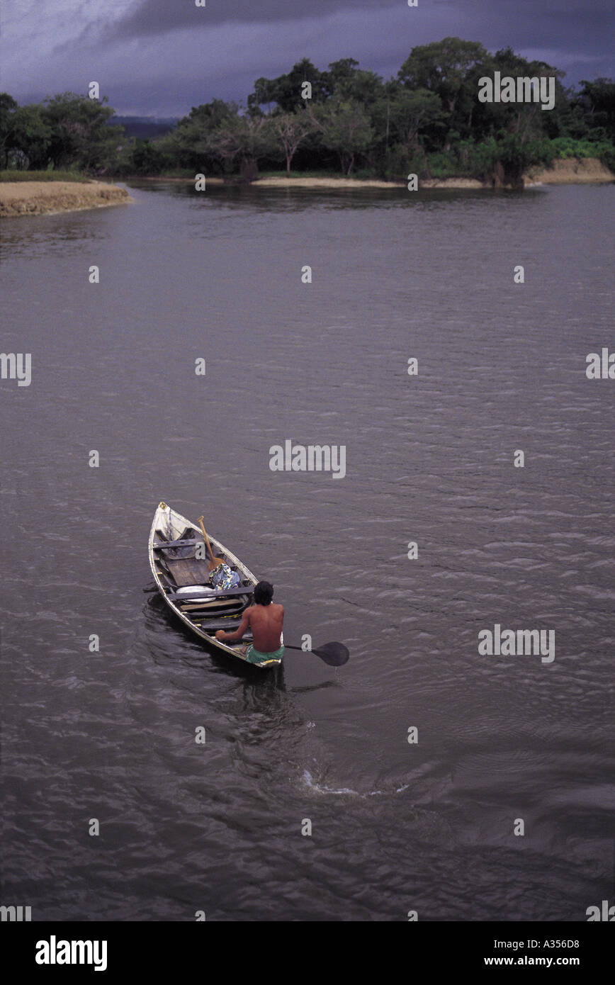 Trombetas River Brazil Caboclo man paddling a small canoe Para State ...