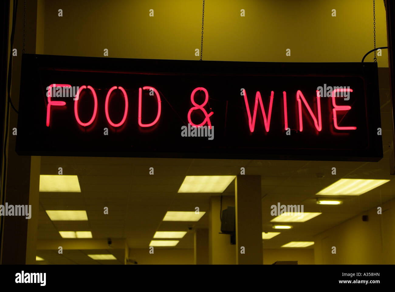 A lit food & wine sign hanging from the ceiling Stock Photo - Alamy