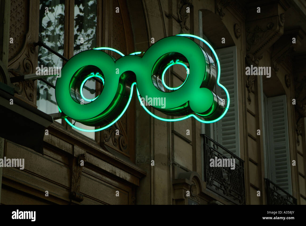 A optician sign which is a pair of green glasses lit up. Paris, France ...