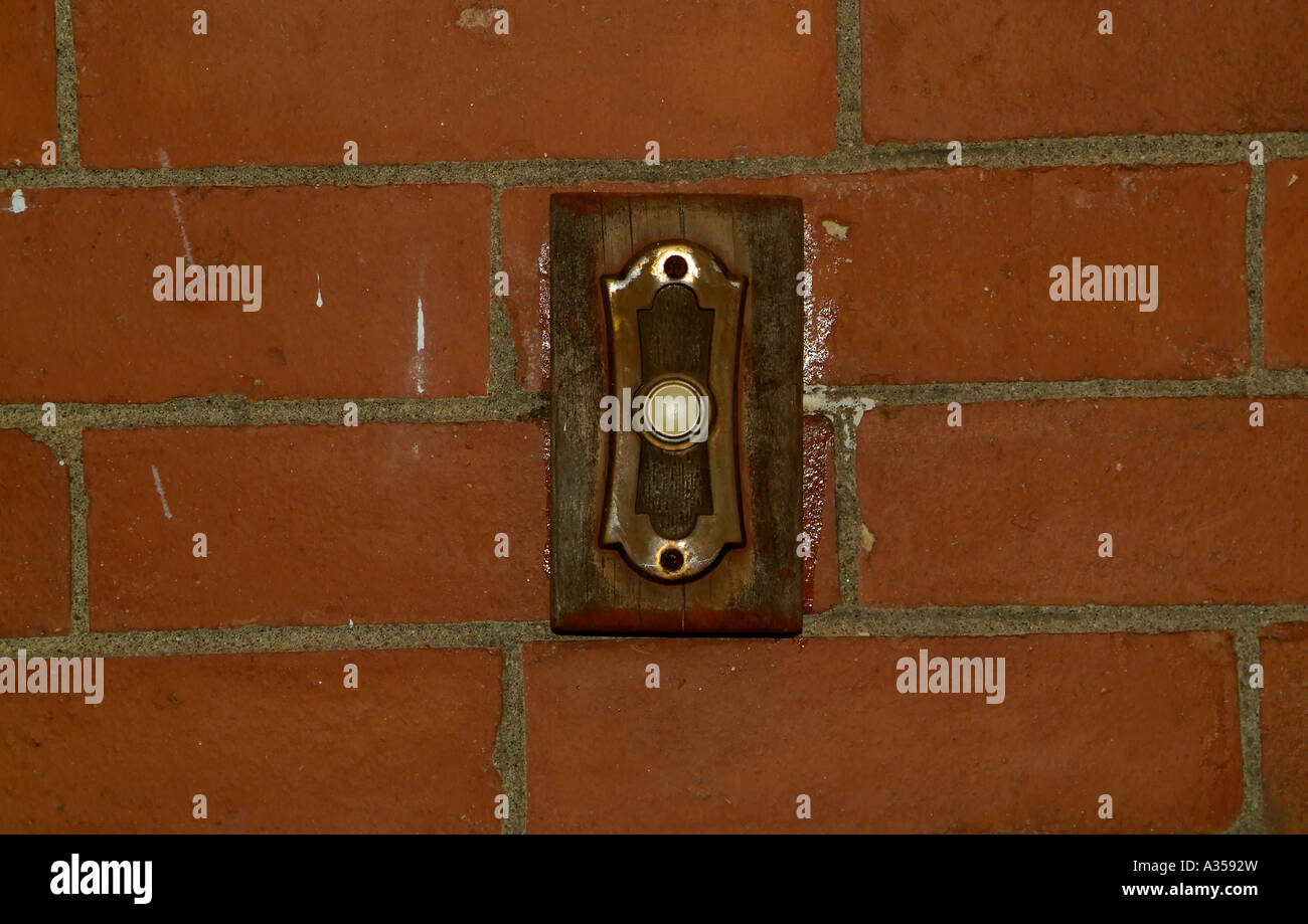 An antique doorbell button on a red brick wall Stock Photo - Alamy