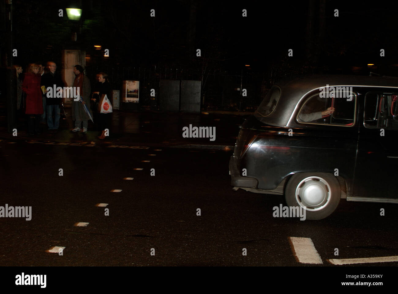 The rear end of a London taxi as it drives by at night Stock Photo - Alamy