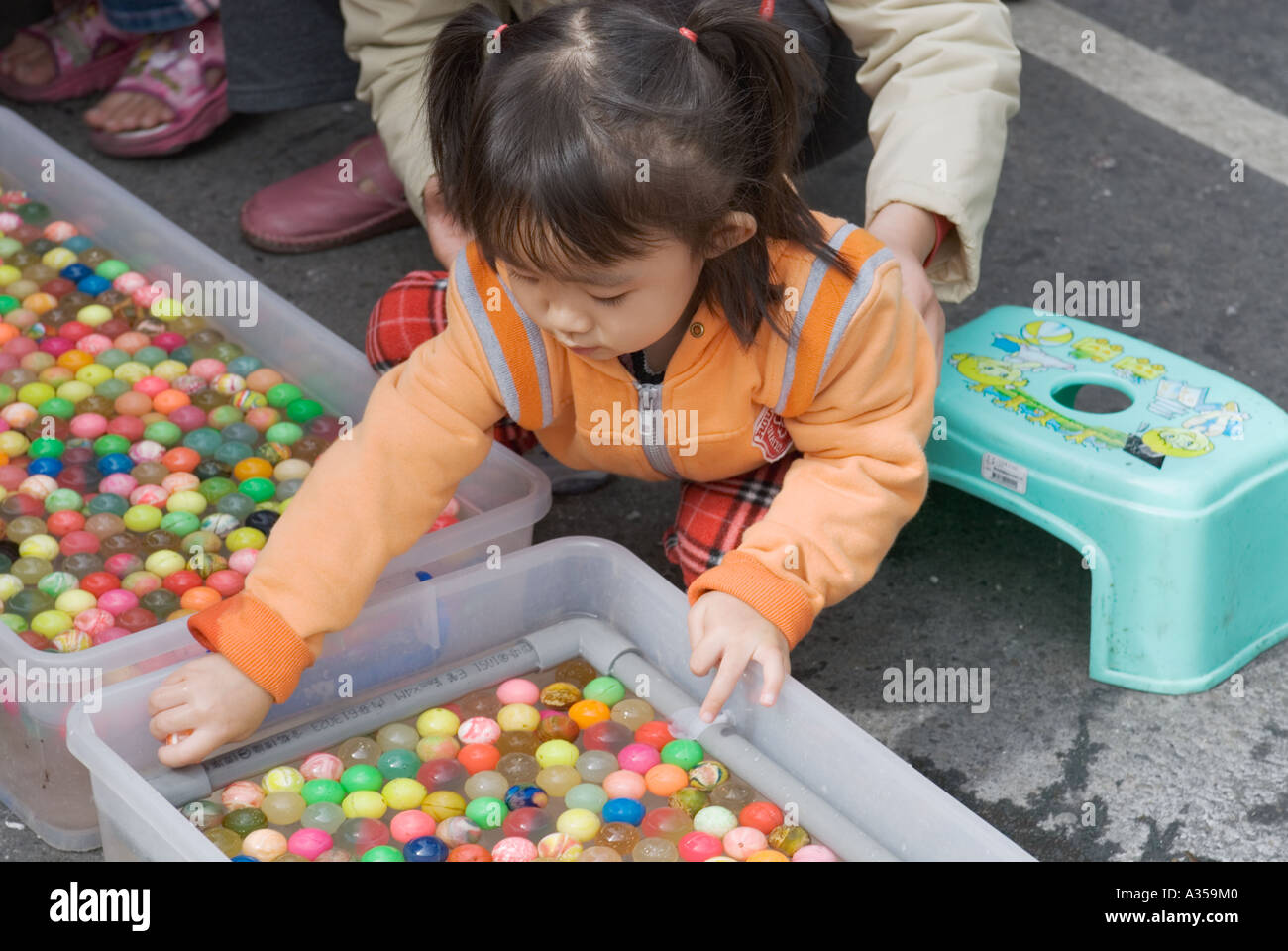 Cute chinese children playing balls hi-res stock photography and images ...
