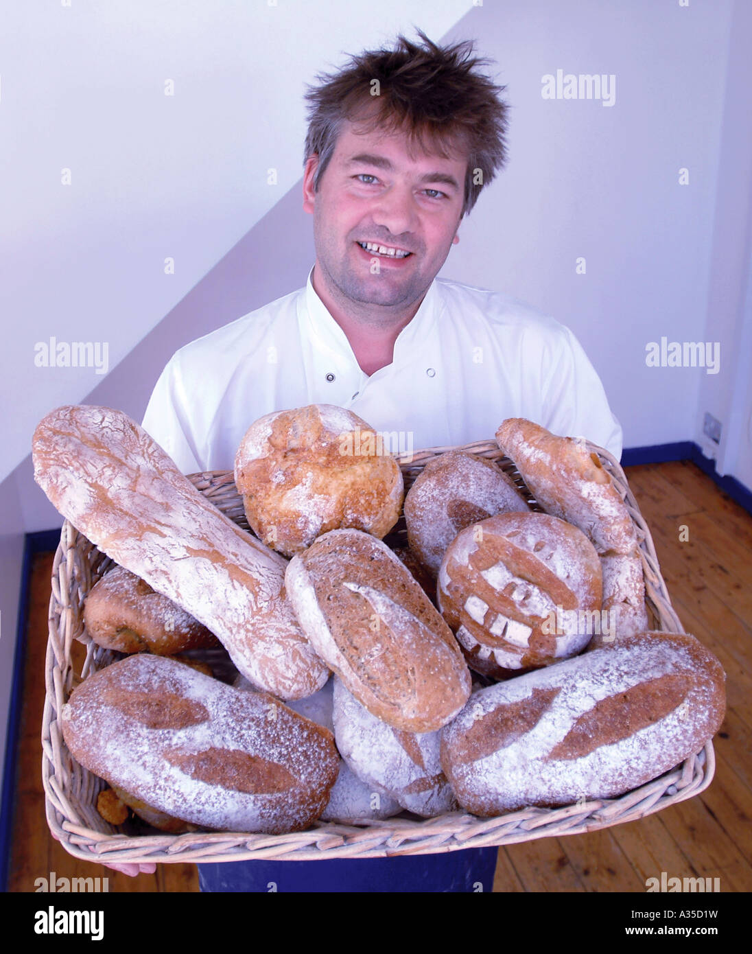 Baker holds a freshly baked loaf of bread UK Stock Photo - Alamy