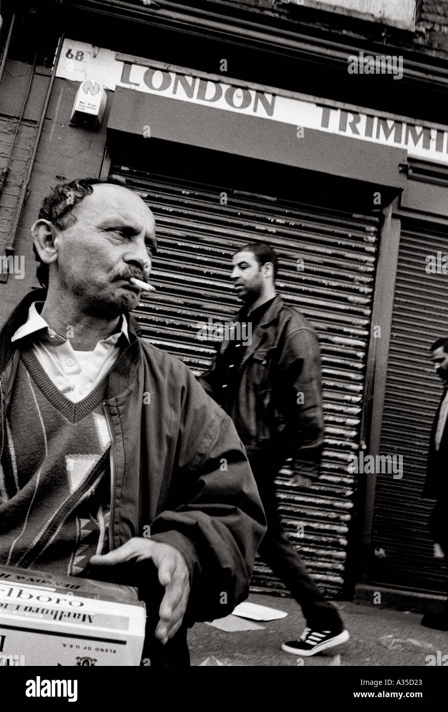 Man selling boxes of cigarettes in "Brick Lane" Market London England ...