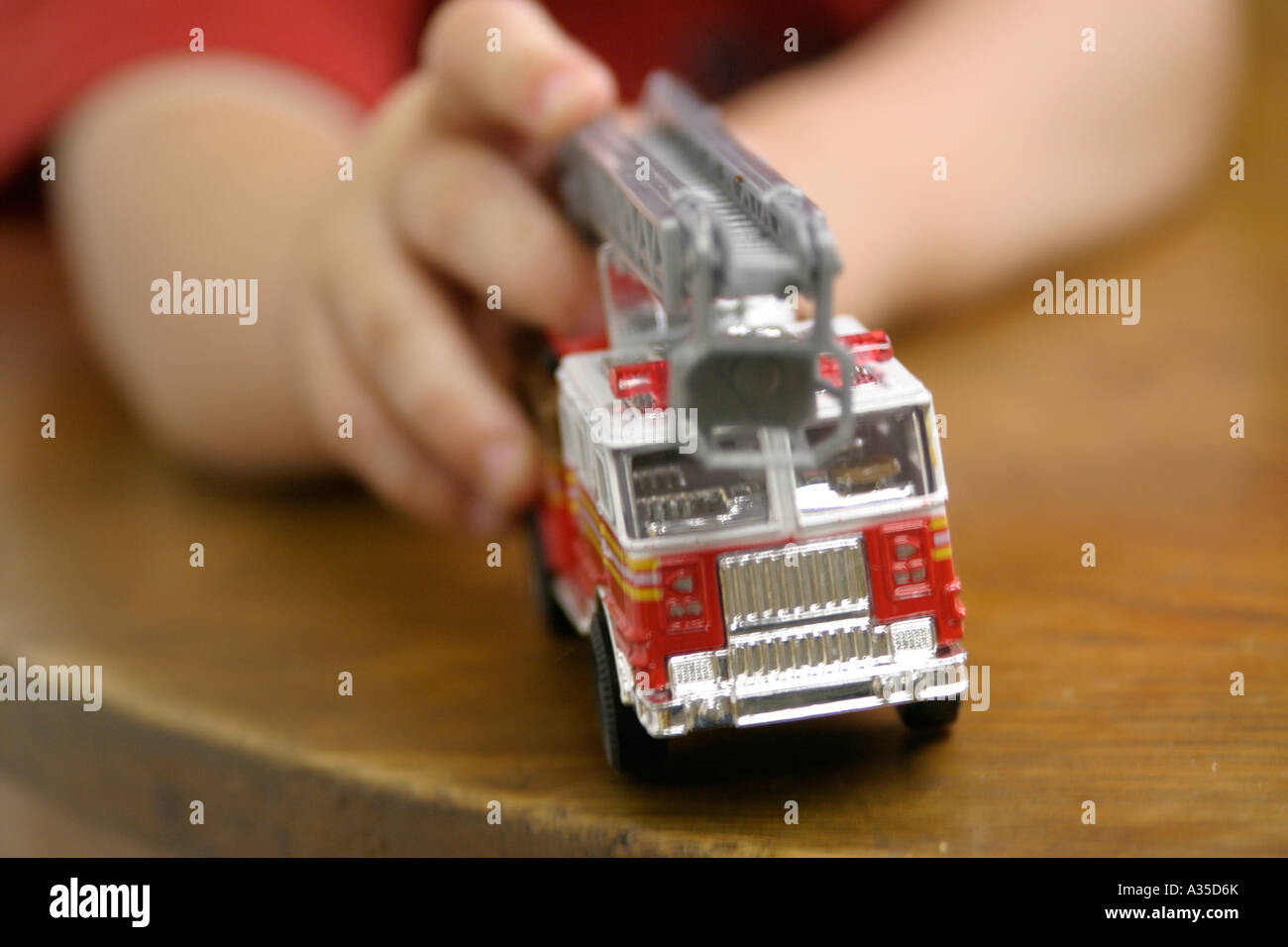 Boy Playing with Fire Truck Stock Photo - Alamy