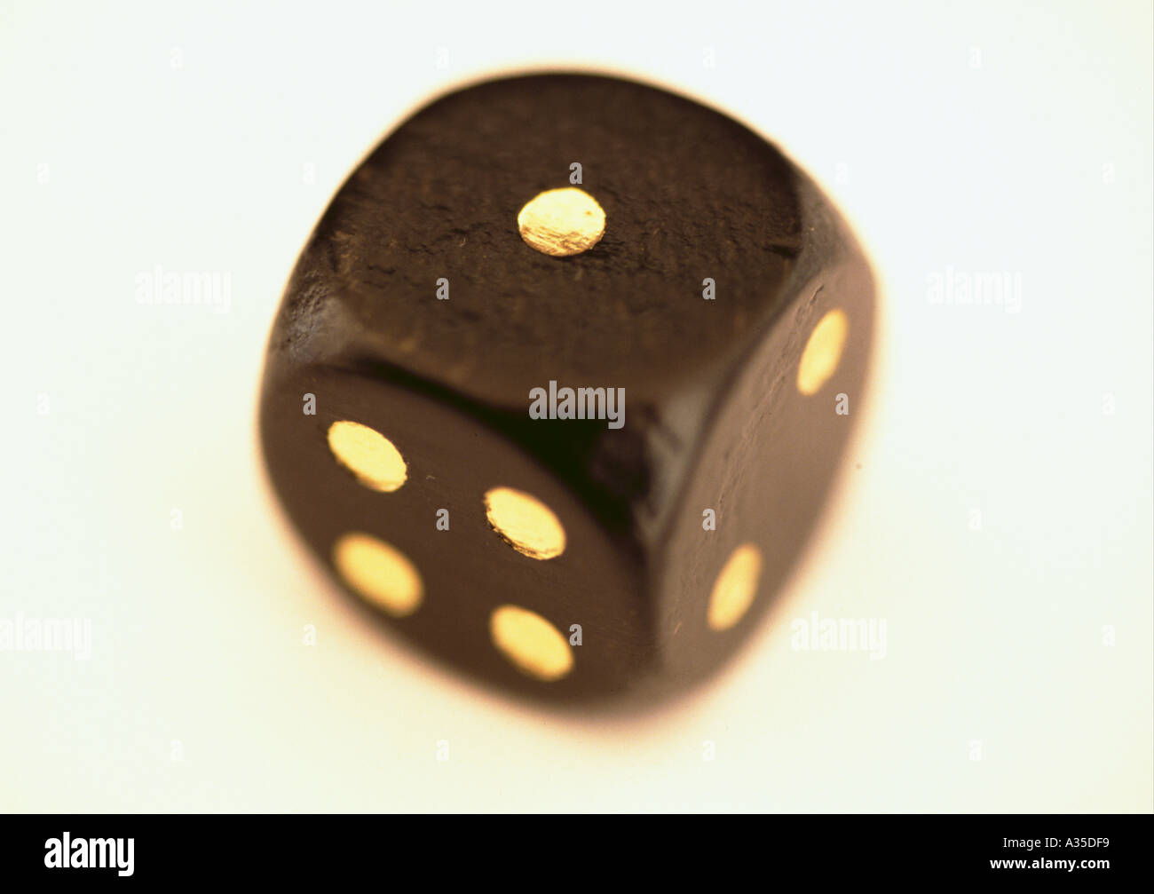 Dices a black dice showing one Stock Photo - Alamy