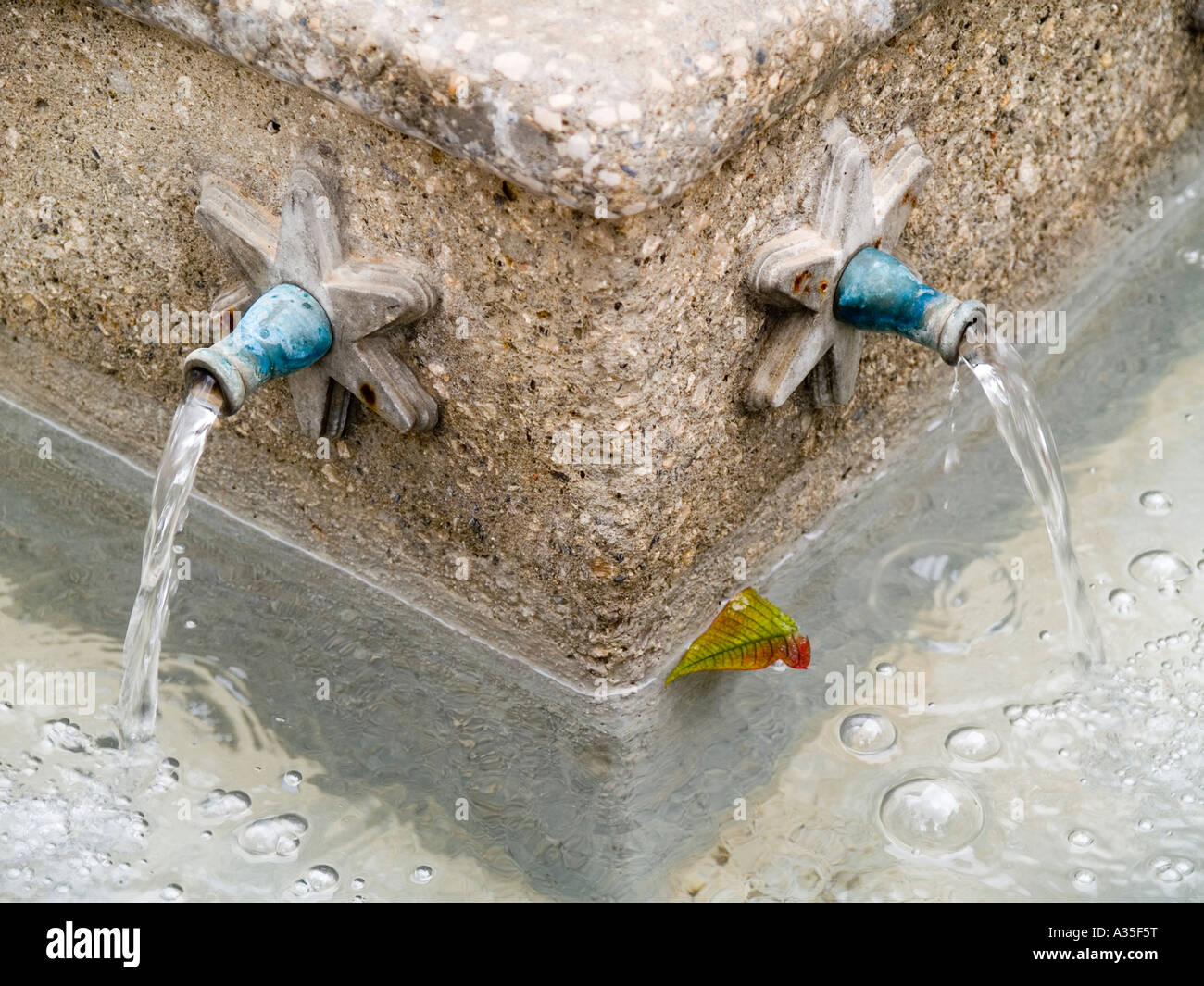Water running from nozzles in a public fountain in Ojen a mountain ...