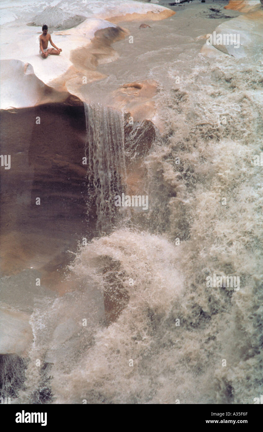 Indian sadhu meditating yoga waterfall source of Ganges river in ...