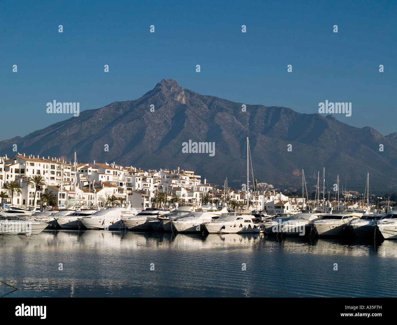 Yacht harbour with mountain backdrop at Puerto Banus Marbella Andalusia ...