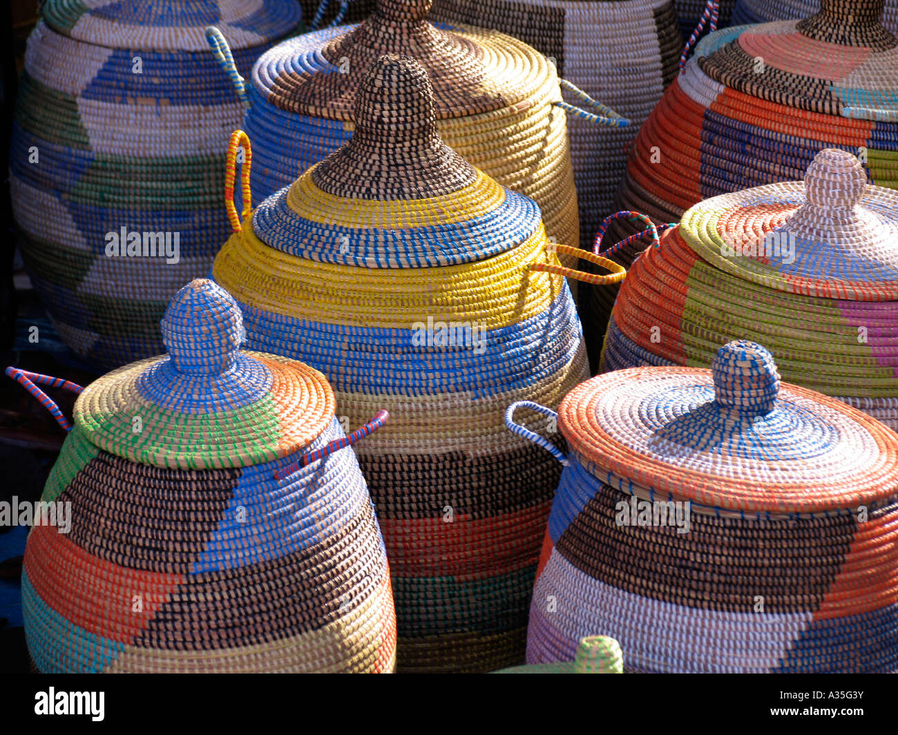 Coloured baskets on sale at market in Spain Stock Photo - Alamy
