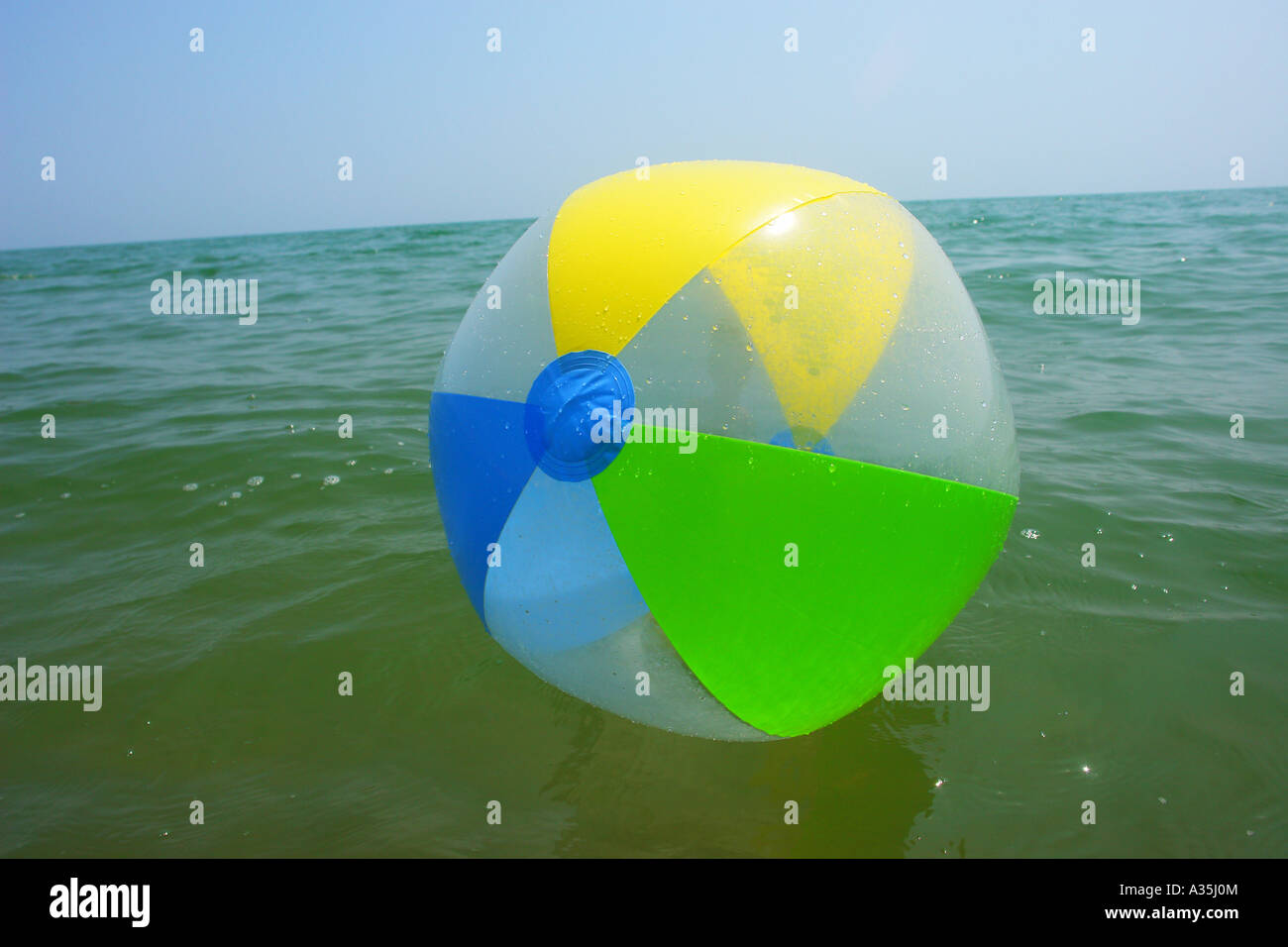 Beach ball at the ocean Stock Photo - Alamy