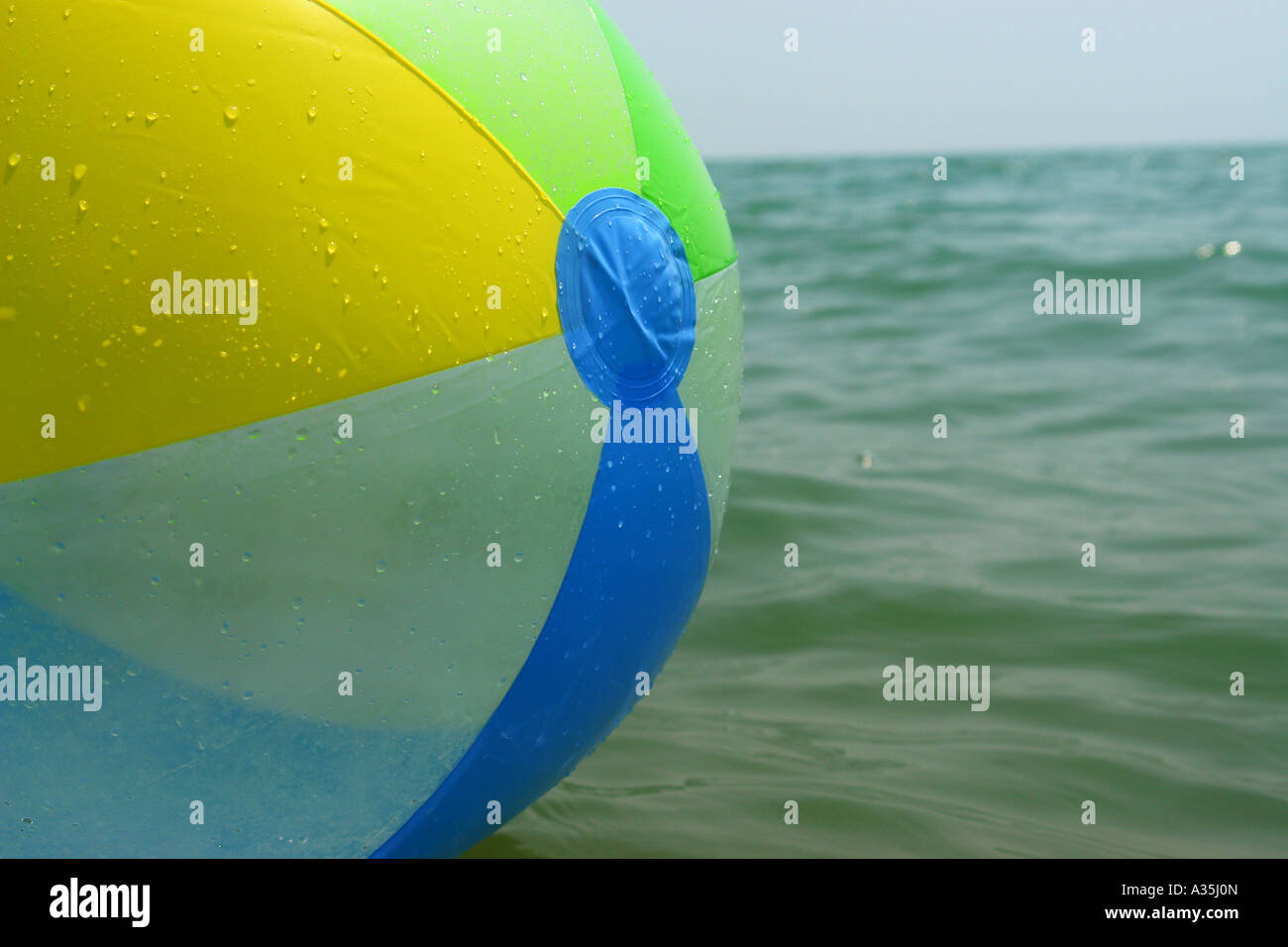 Beach ball at the ocean Stock Photo - Alamy