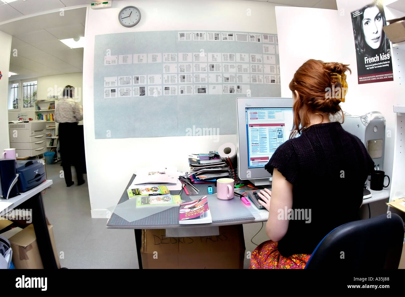 Female EDITOR WORKING ON MAC COMPUTER IN PUBLISHING Business COMPANY ...