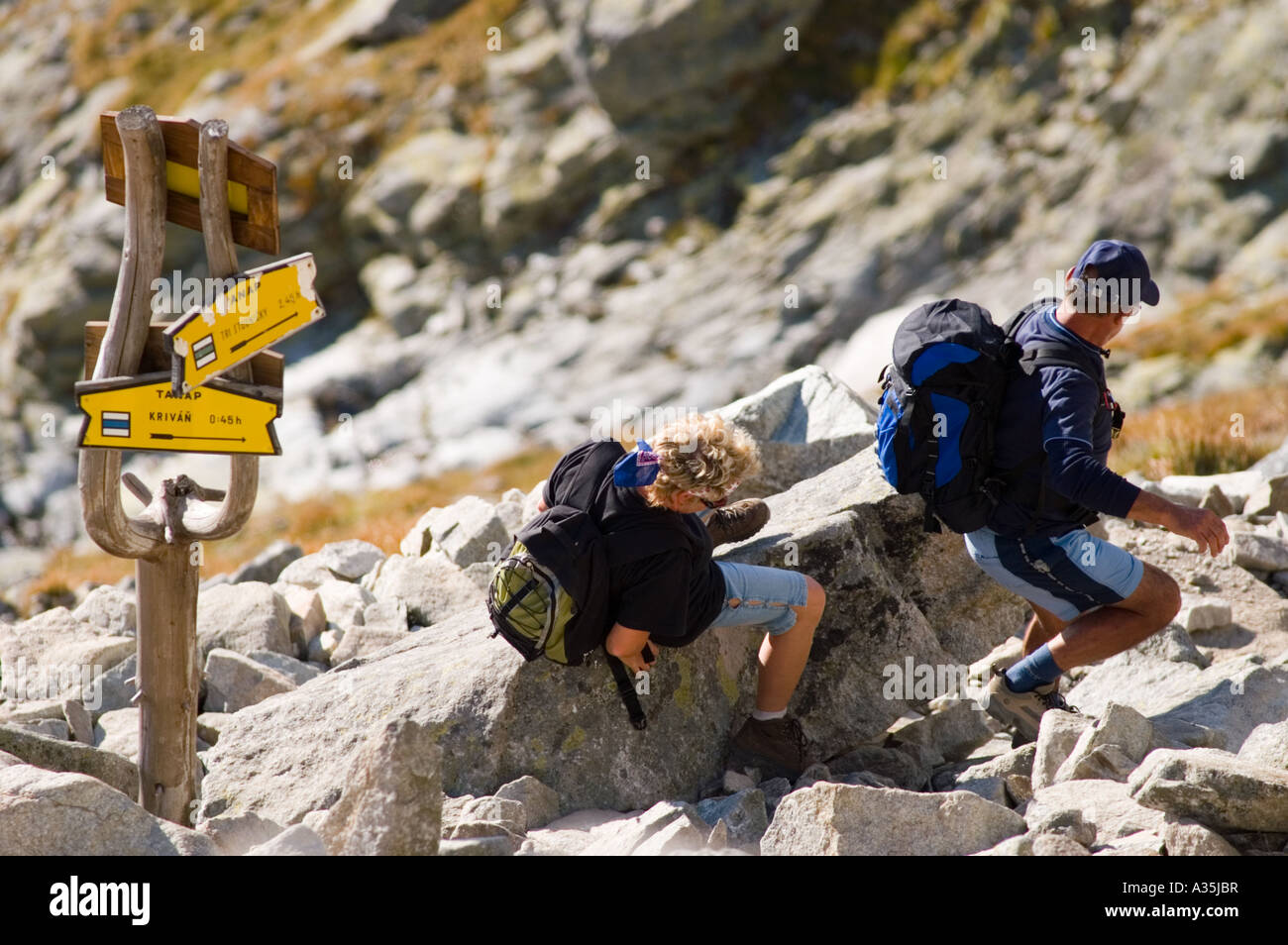Tourists descending on a trail, one falling down on a rock Stock Photo ...