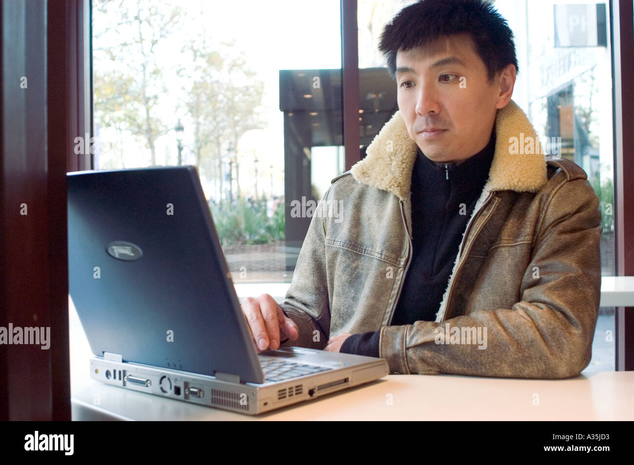 Chinese Man Looking at Laptop Computer Screen, in Mc-Donald's ...