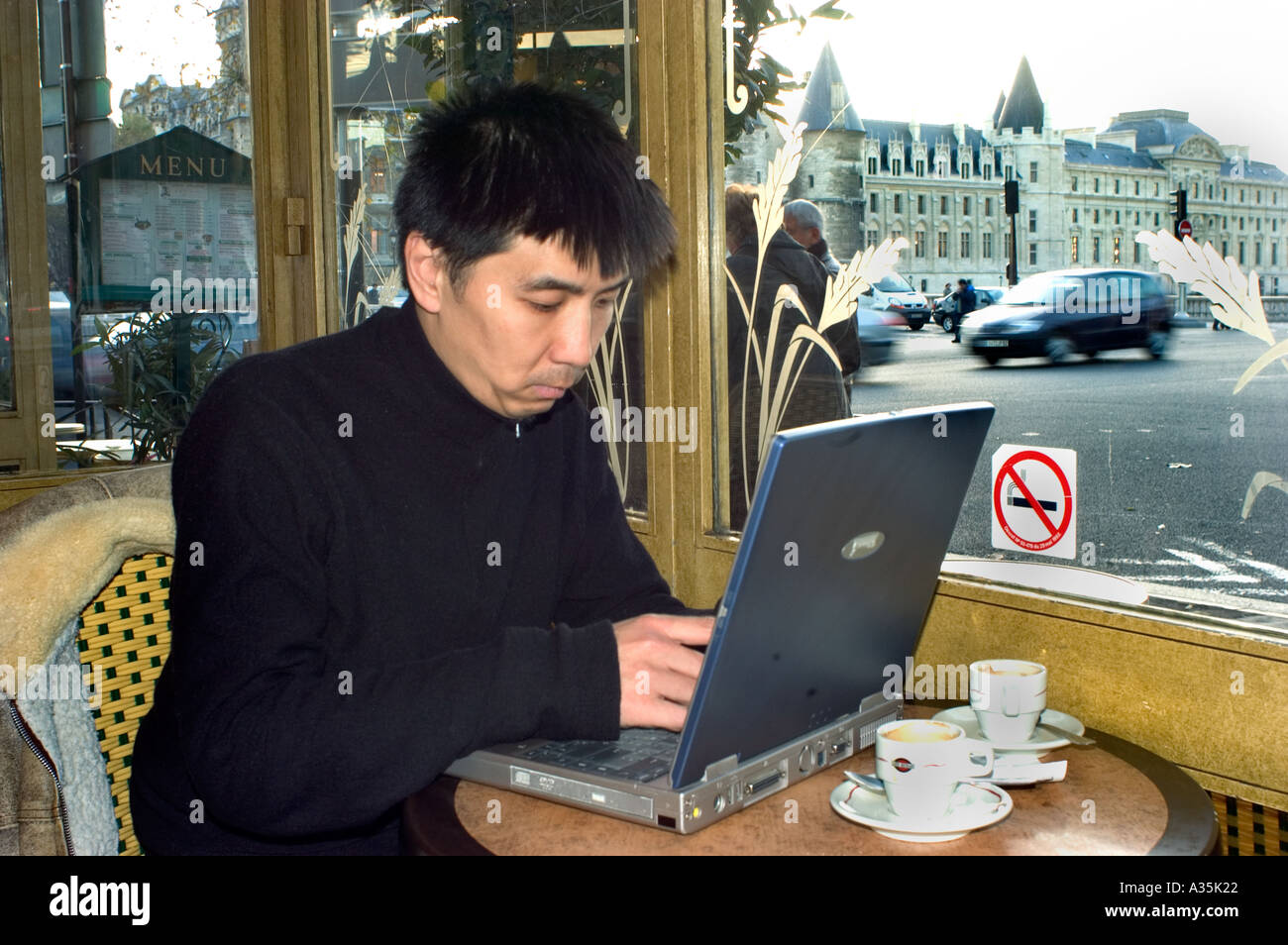 Chinese Man Working, in Paris Cafe, Looking at Laptop Computer Screen ...