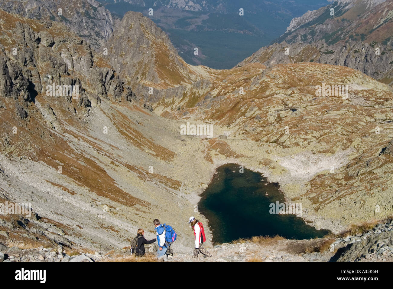 A farther with children hiking, passing the Polish ridge, Hight Tatras ...