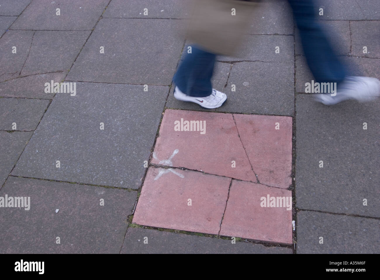 pedestrian walking on cracked broken paving stone pavement Stock Photo ...
