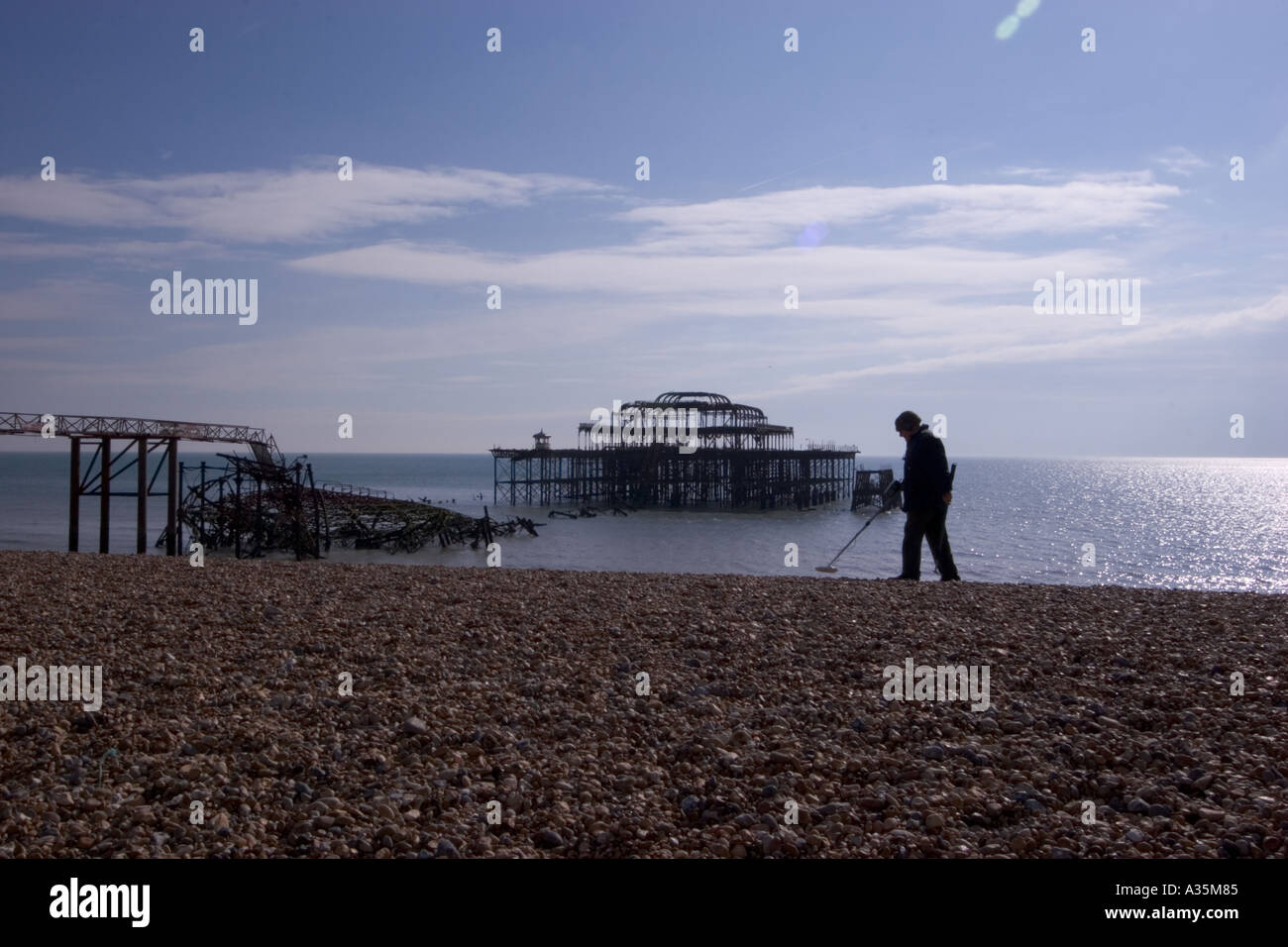 Male detectorist hunting for treasure beachcombing on Brighton seafront ...