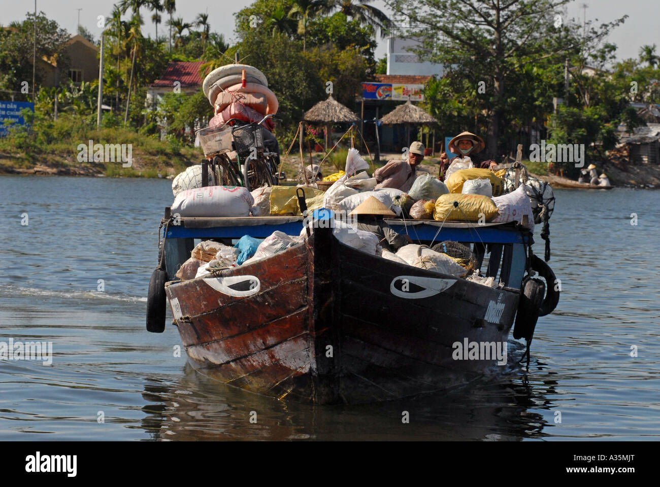 Ferry on Thu Bon River transporting local people arriving at the ...