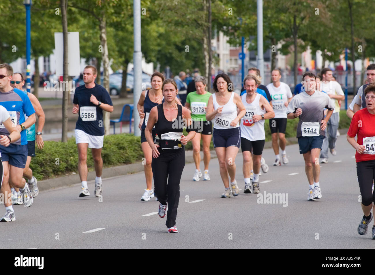 a group of runners with a female leading Stock Photo - Alamy