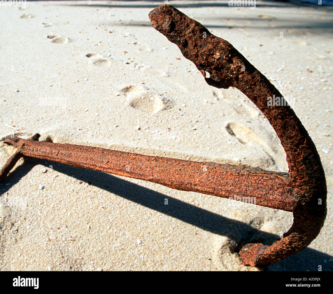 An old and rusty anchor laying on a beach, Brazil Stock Photo - Alamy