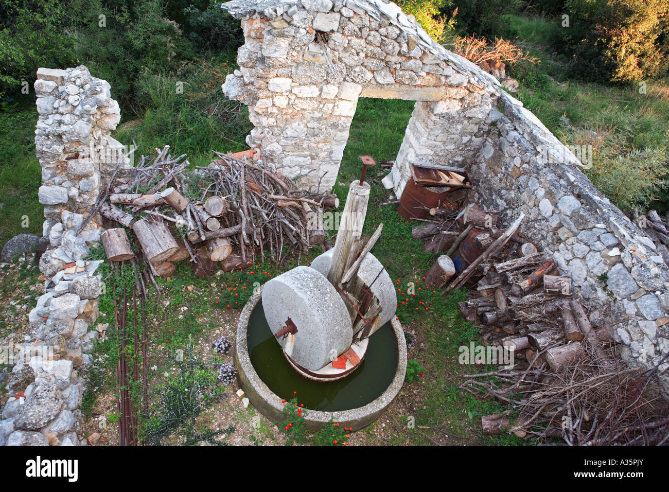 An old stone wheel used for crushing olives Stock Photo - Alamy