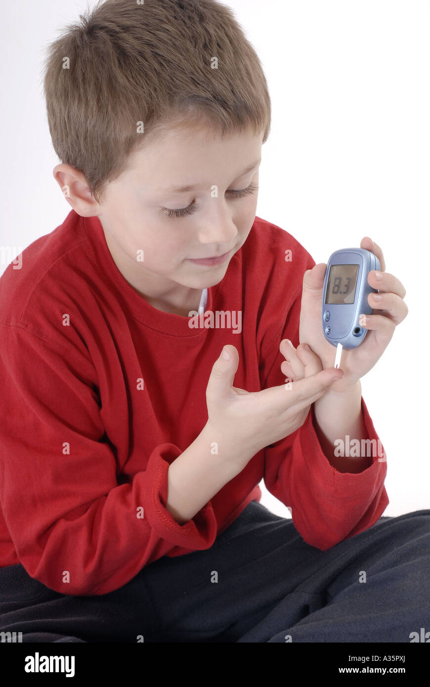 Young diabetic boy doing blood glucose test Stock Photo - Alamy