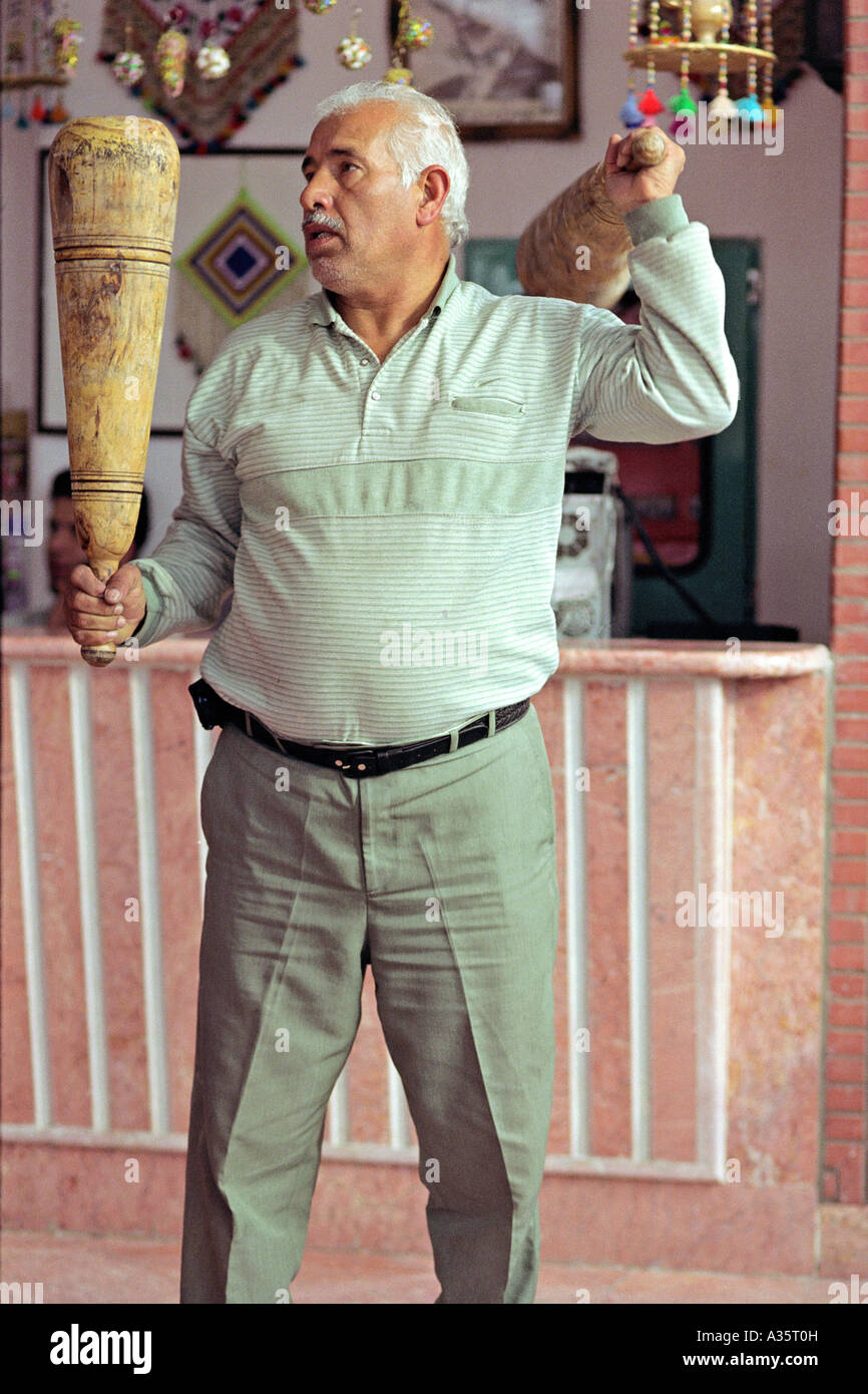 A man demonstrates the use of meels (Indian Clubs) at the Abyaneh Hotel ...