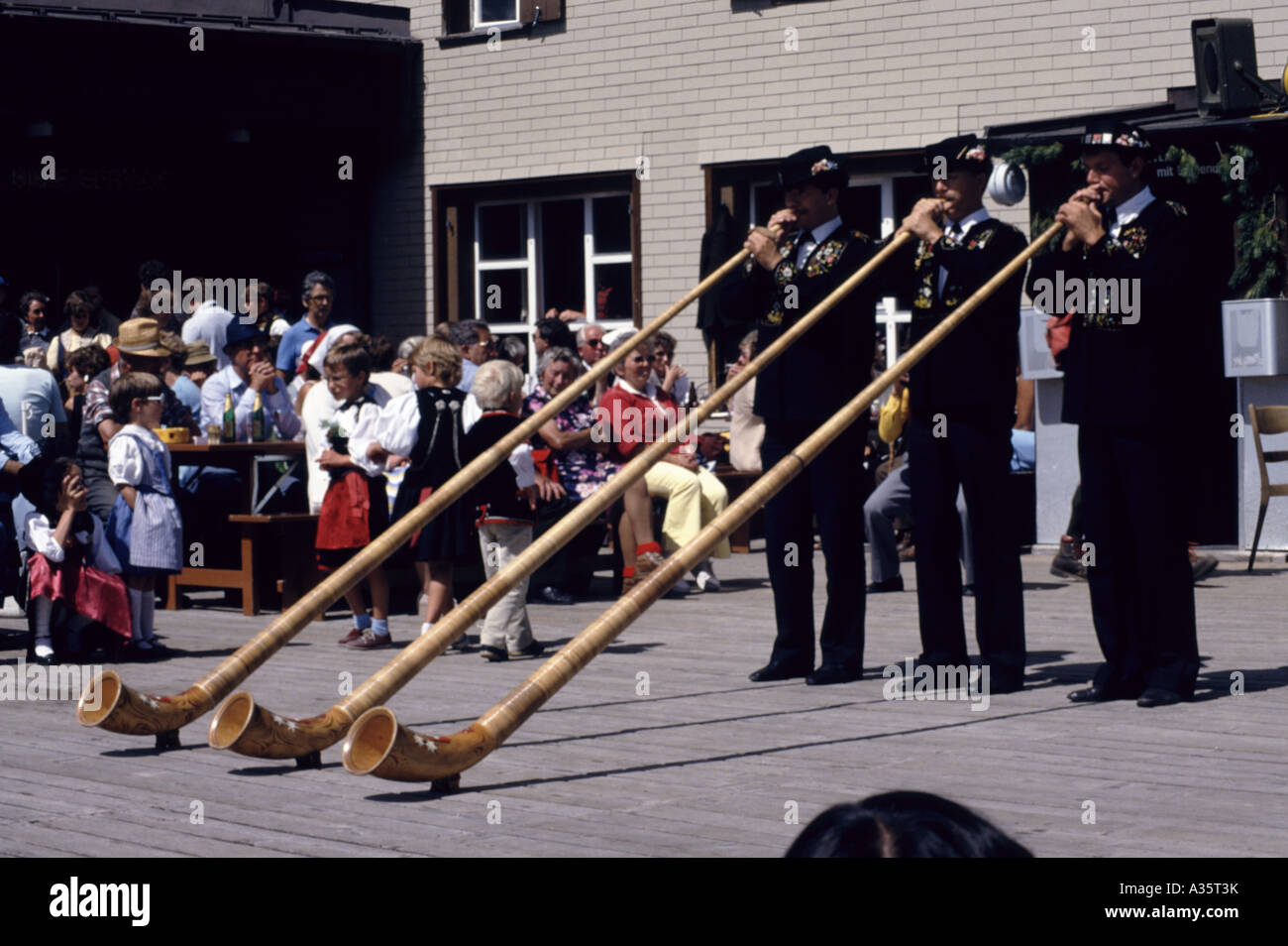 Yodelers blowing on Alp horns in Switzerland Europe Stock Photo - Alamy