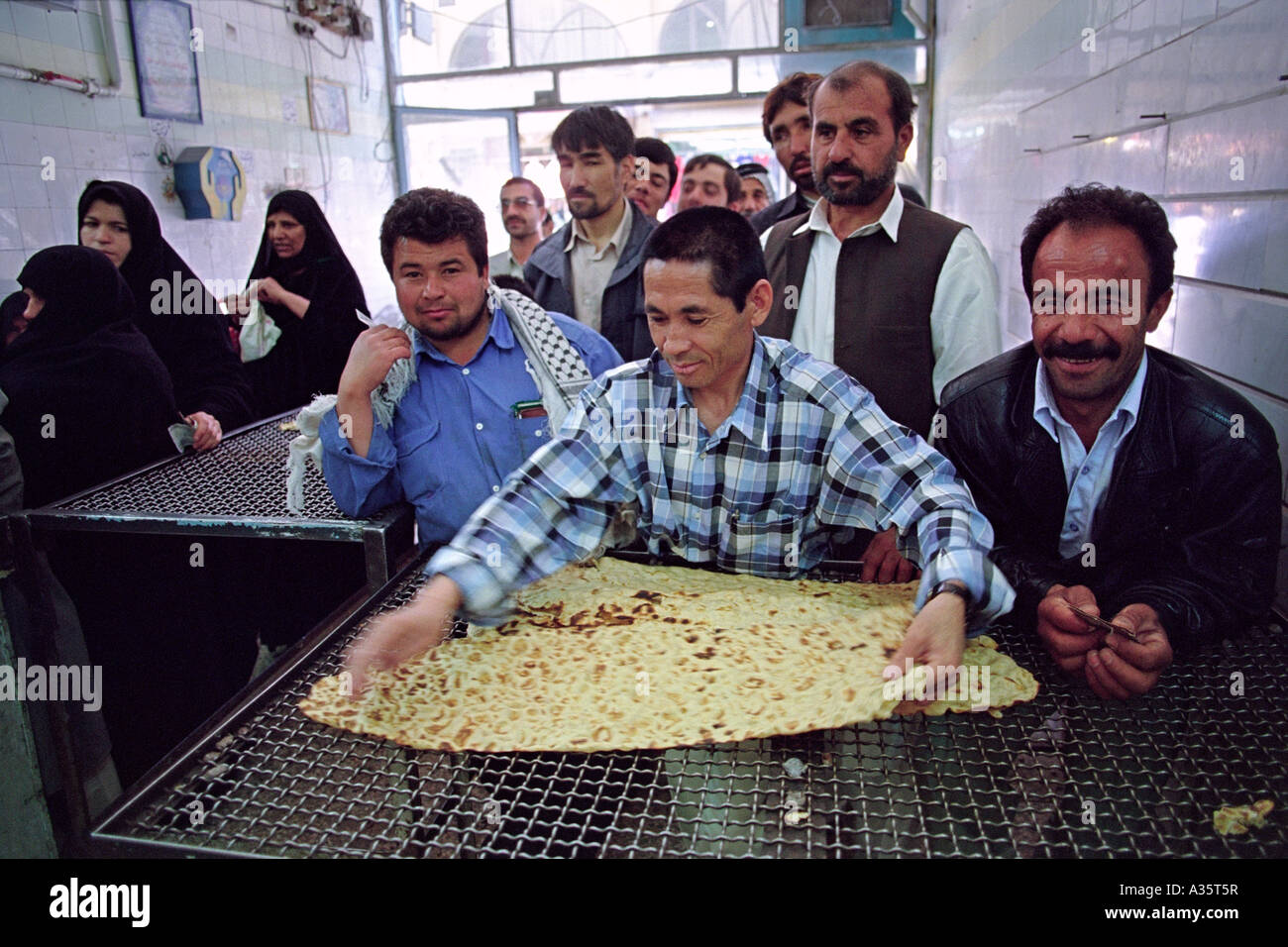 Buying sangak bread in the holy city of Qom Iran Stock Photo - Alamy