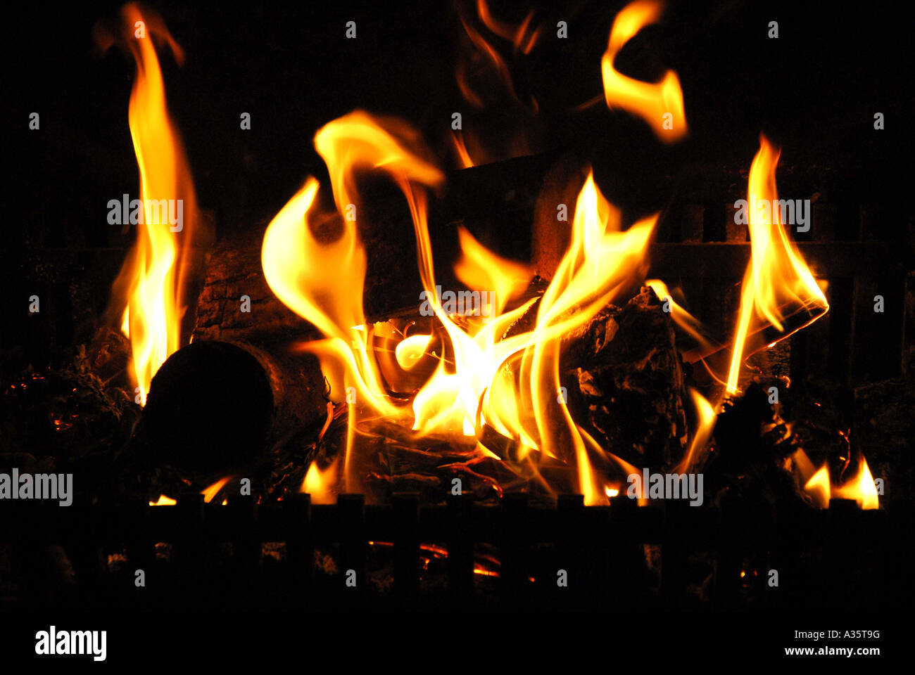 Fireplace with a log fire Stock Photo - Alamy