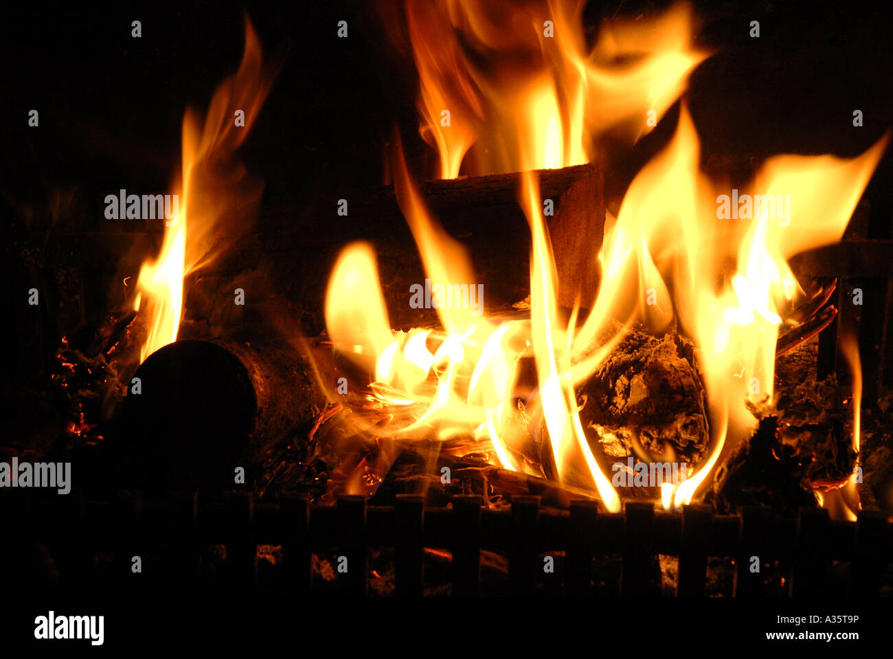 Fireplace with a log fire Stock Photo - Alamy