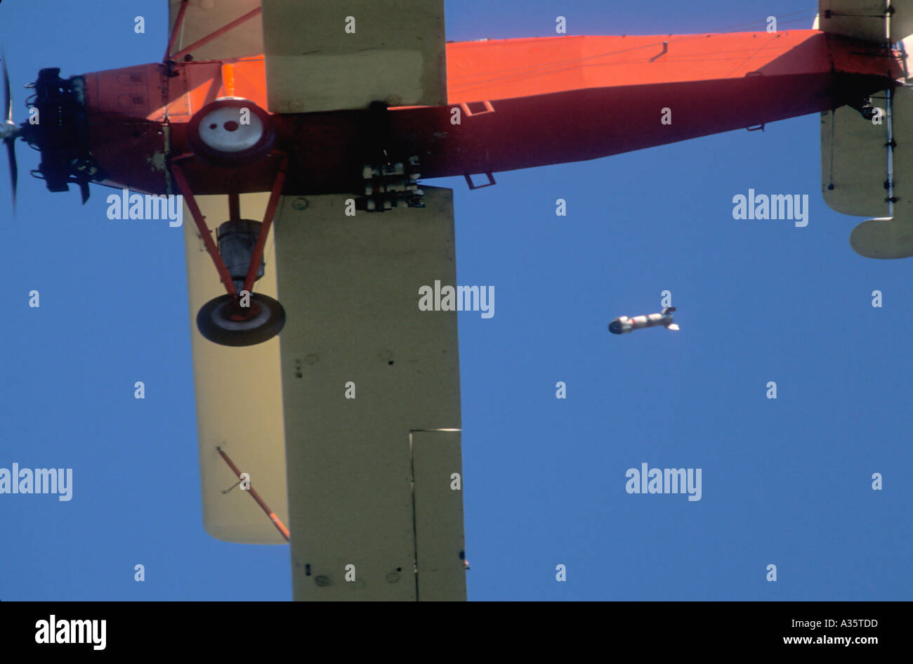 A vintage World War I airplane drops a mock bomb during an air show in ...