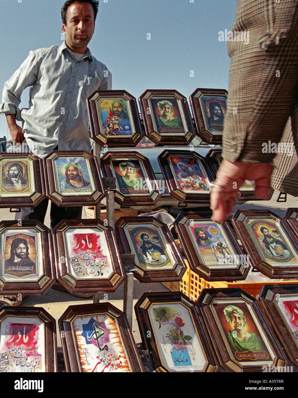 A man sells pictures of martyrs and other religious material in the dry ...